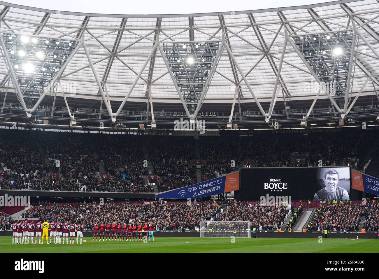 West Ham United and Brentford players stand before a minute's applause ...
