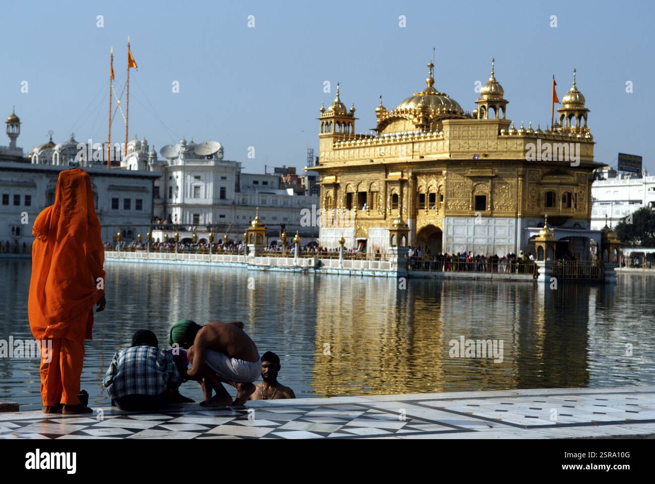 Sikh devotees take bath in holy Amrit sarovar or pond near Sri ...