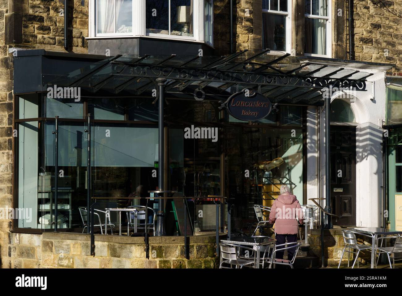 Lancaster's bakery/cafe shopfront with metal chairs and a glass canopy ...
