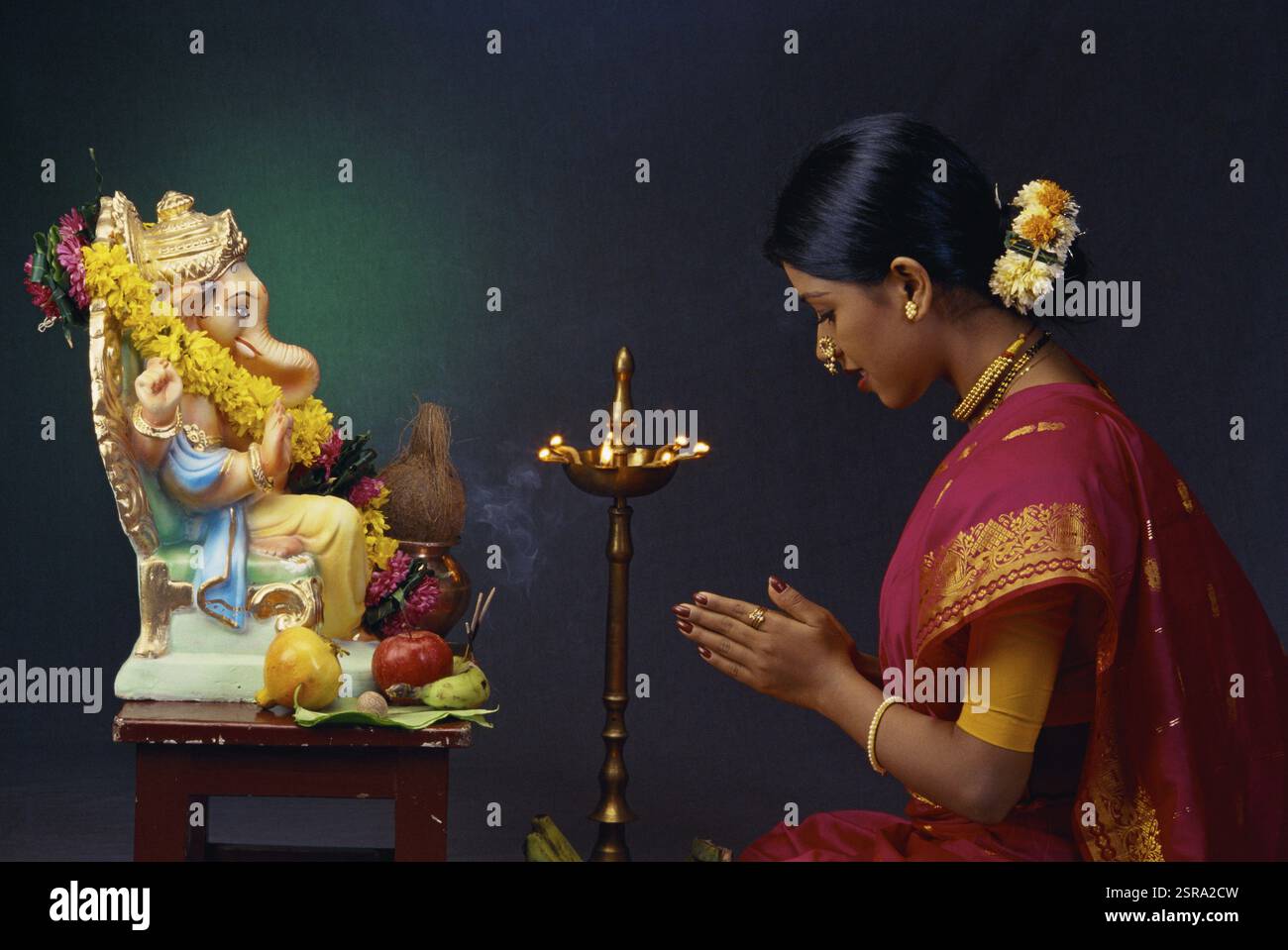 Lady performing pooja in front of god ganesh idol, India MR#138 Stock ...