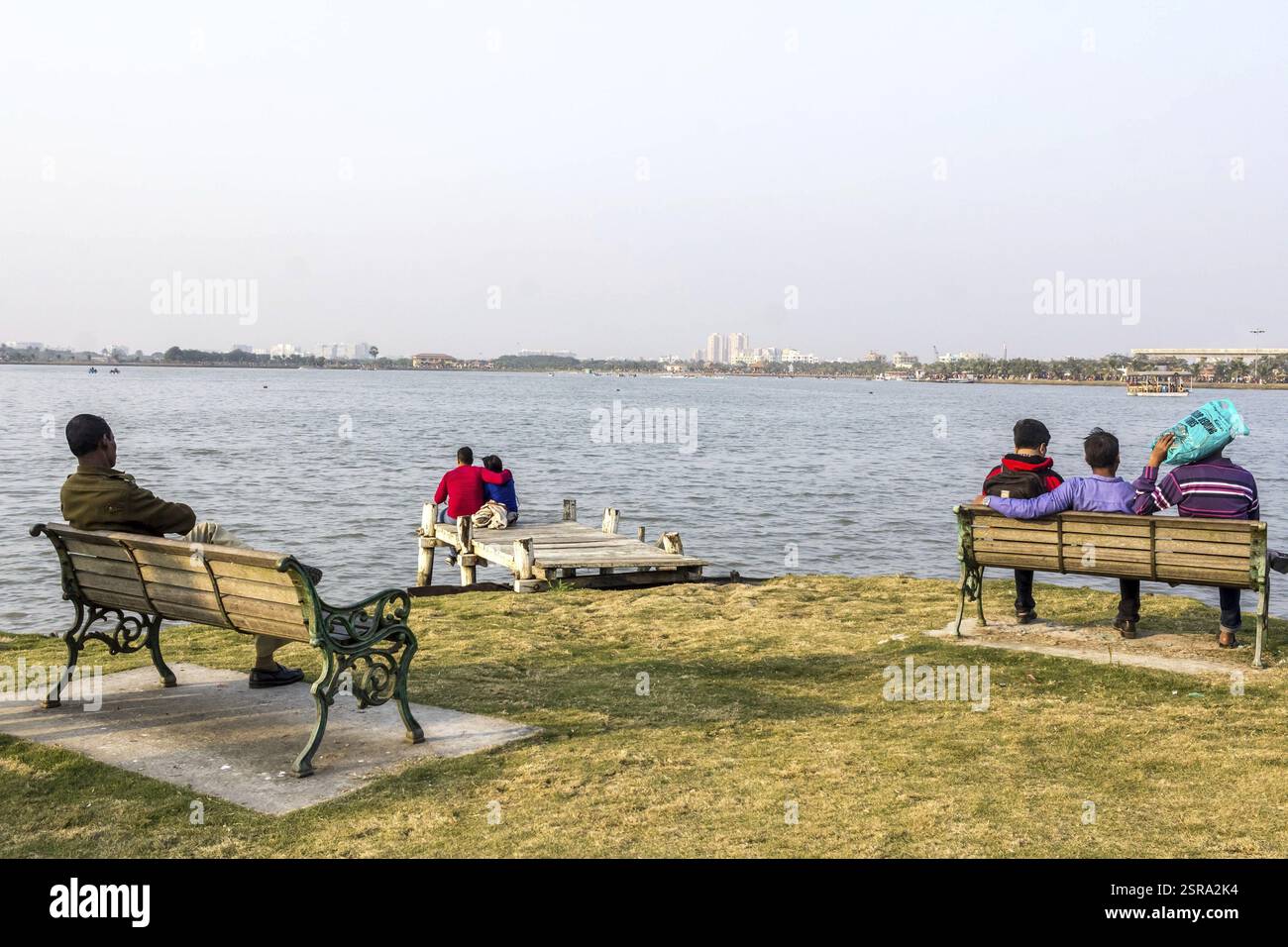 People sitting near lake at amusement park, Kolkata, West Bengal, India ...