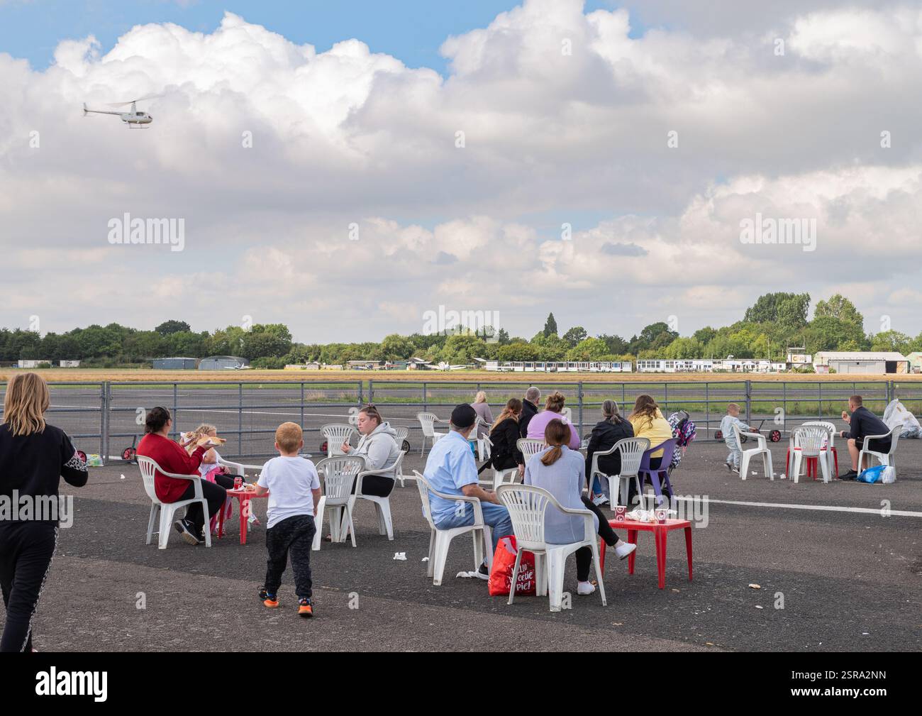 People eating snacks on the runway at Wellesbourne Airfield Market held ...