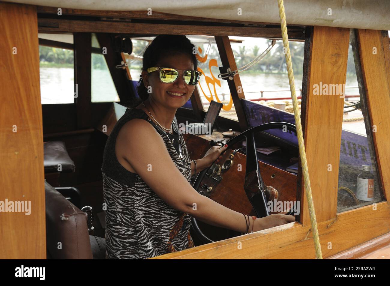 Woman driving boat backwater, Munnar, Kerala, India, Asia, MR#802B ...