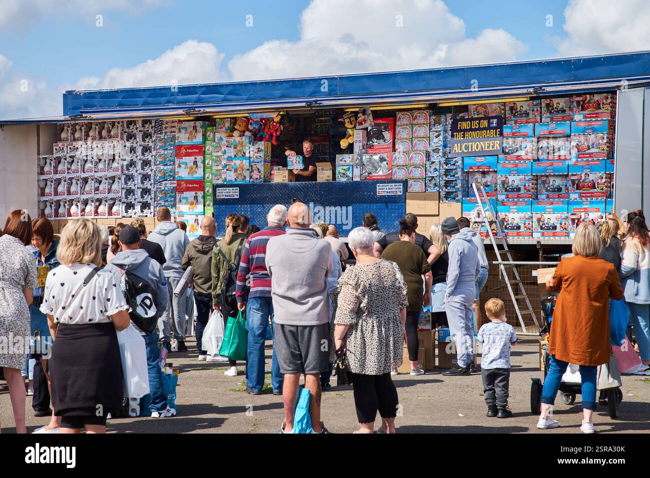 A large stall attracting crowds at Wellesbourne Airfield Market held ...