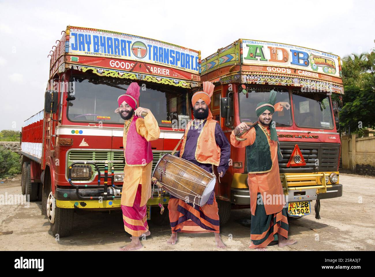 Dancers playing musical instrument dholak holding sticks performing ...