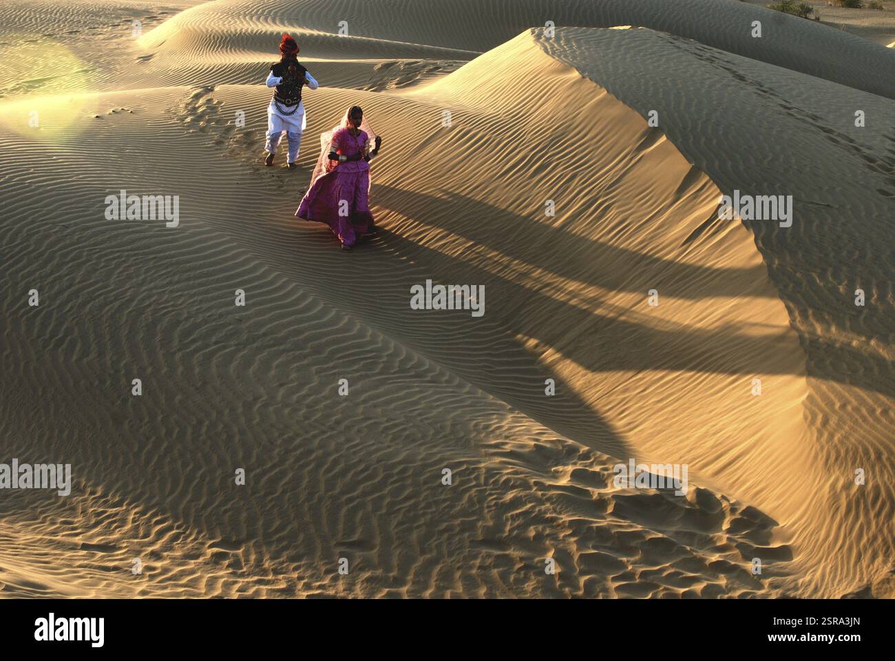 Rajasthani woman and folk musician crossing sand dunes, Khuhri ...