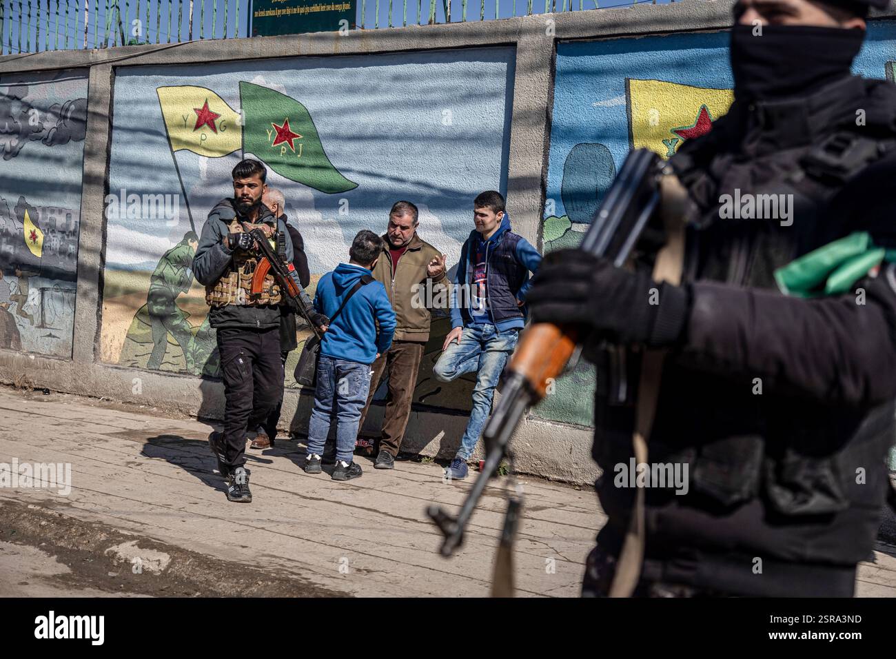 Syrian Democratic Forces (SDF) fighters patrol the area during a ...