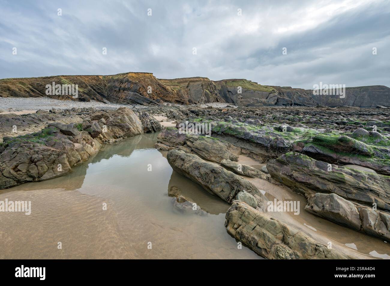 Sandy rockpools on Northcott Mouth beach Cornwall at low tide Stock ...