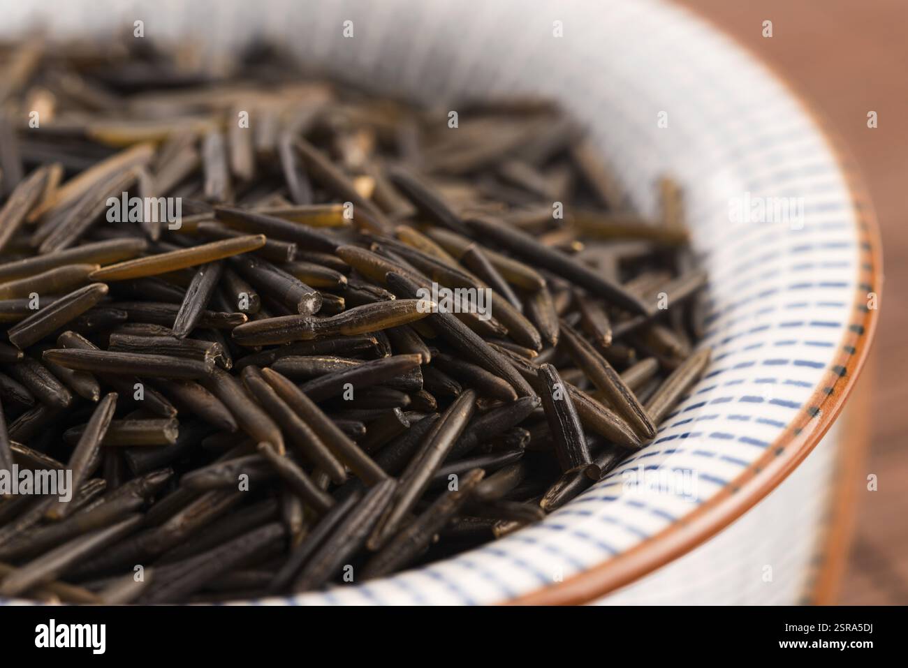 Wild rice in a white ceramic bowl Stock Photo - Alamy