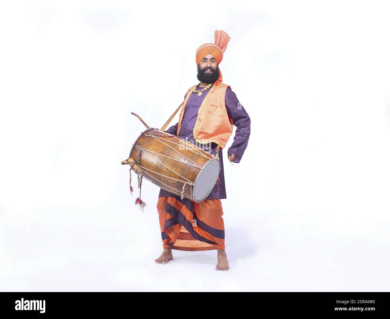 Dancer playing musical instrument dholak in folk dance bhangra MR#779C ...