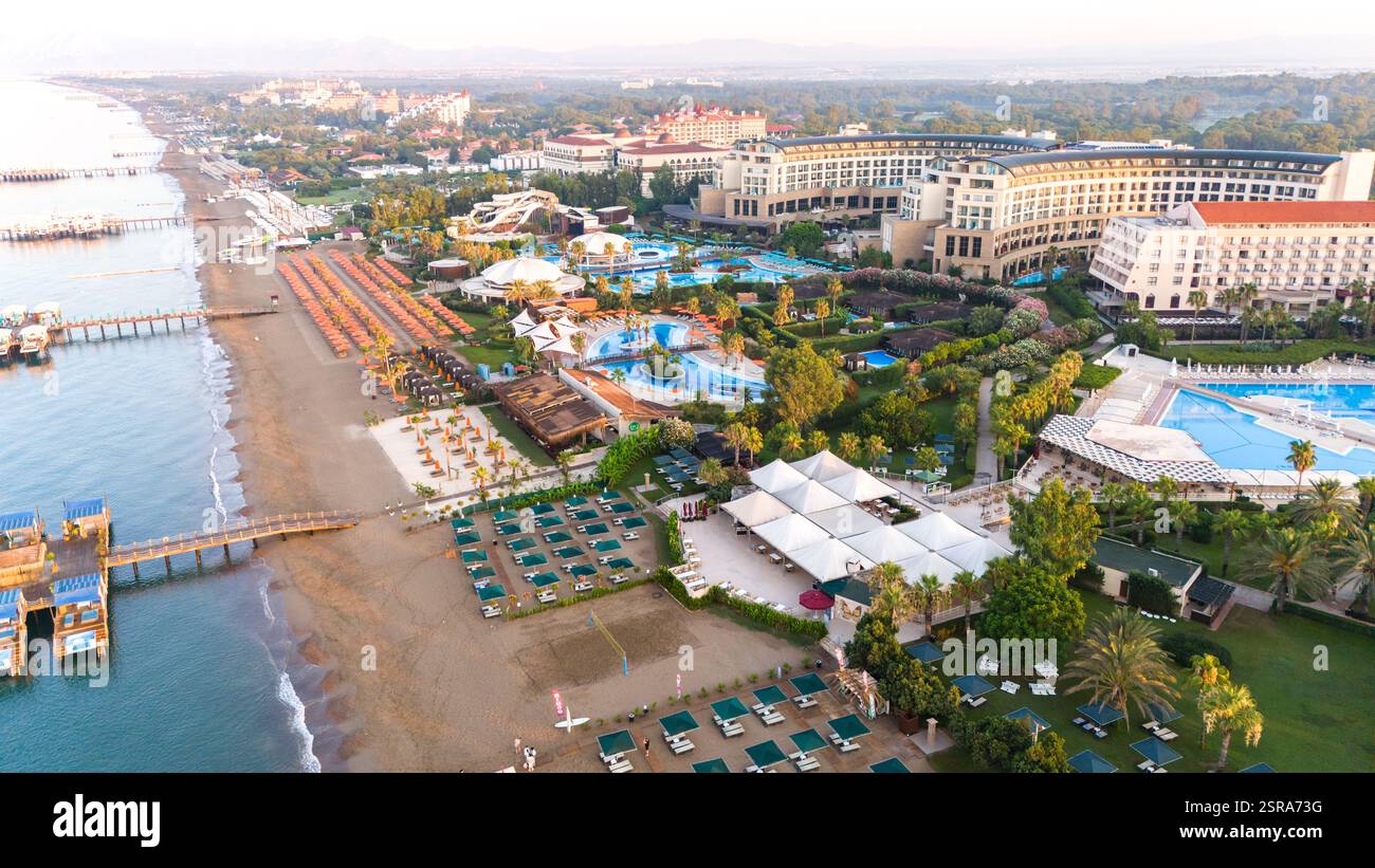 Aerial view of a luxury beachfront resort with pools, private piers ...