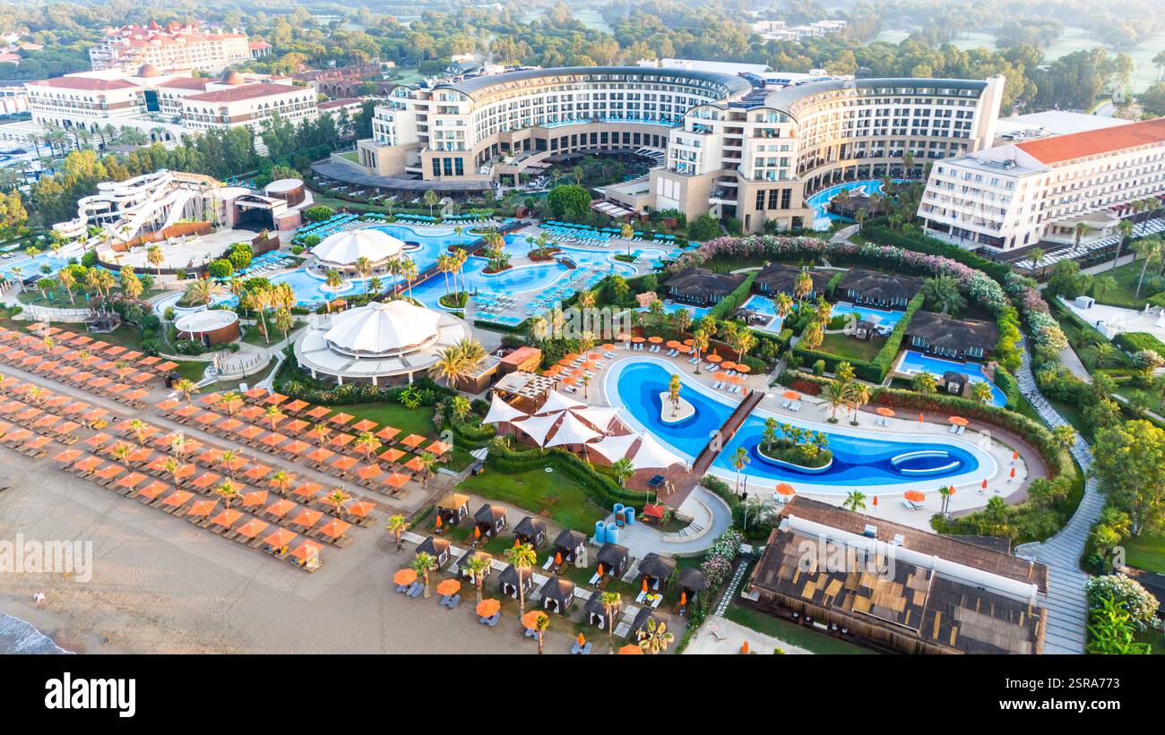 Aerial view of a luxury beachfront resort with pools, a water park, and ...