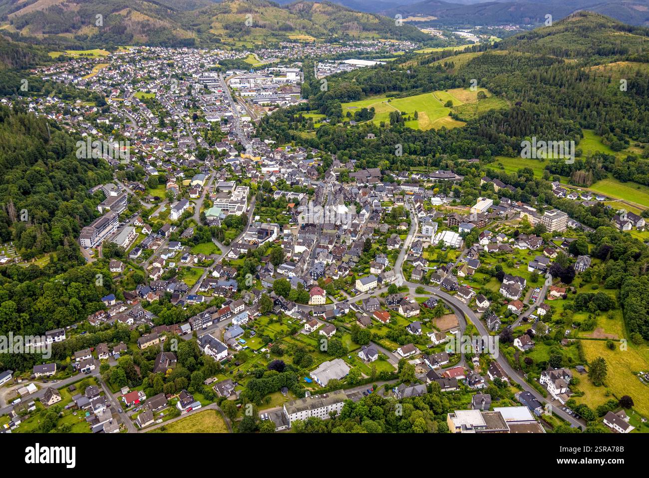 Aerial view, residential area village view, surrounded by hilly forest ...