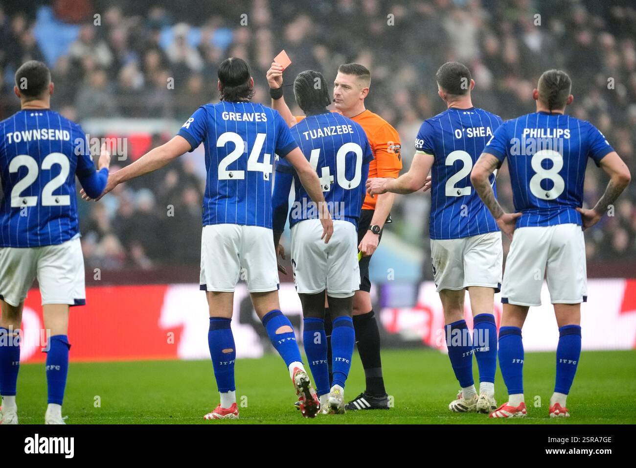 Ipswich Town's Axel Tuanzebe (centre) is shown a red card by referee ...