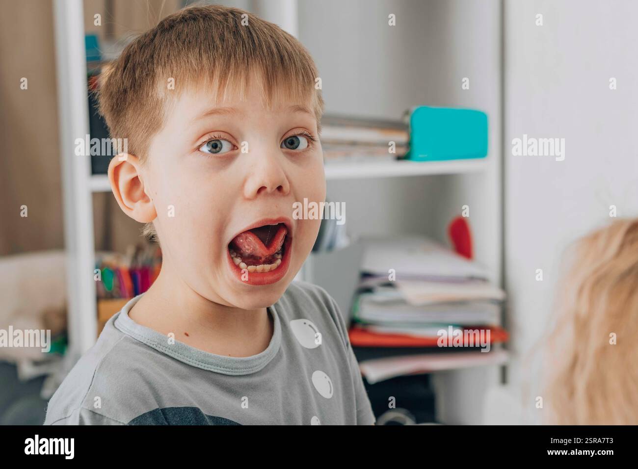 boy, tongue movement during speech therapy session, receiving ...