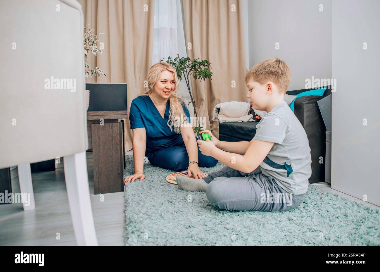 Child participating in a therapy session with a professional using a ...