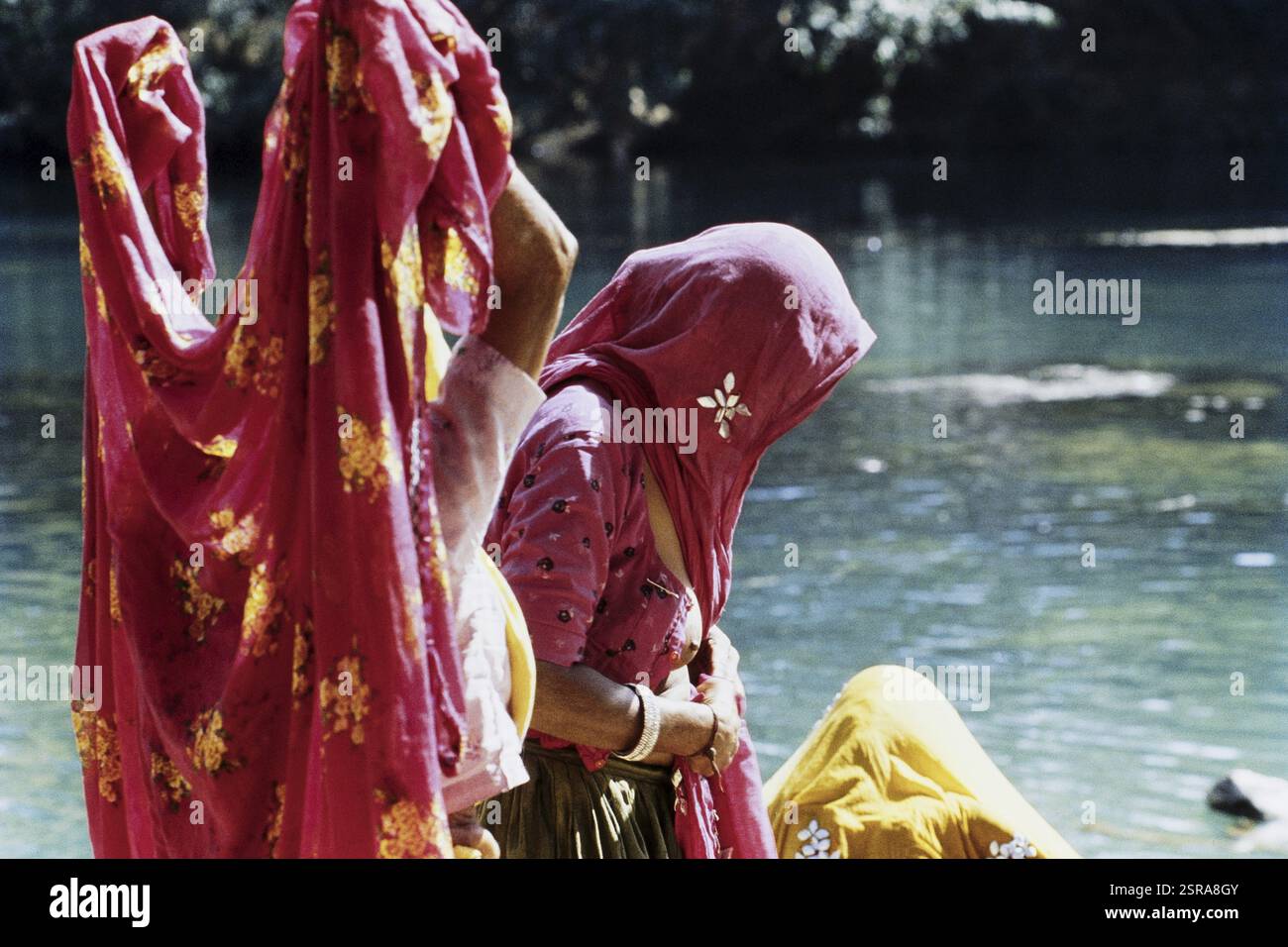 Women bathers bathing and changing clothes during Kumbh Fair, India ...