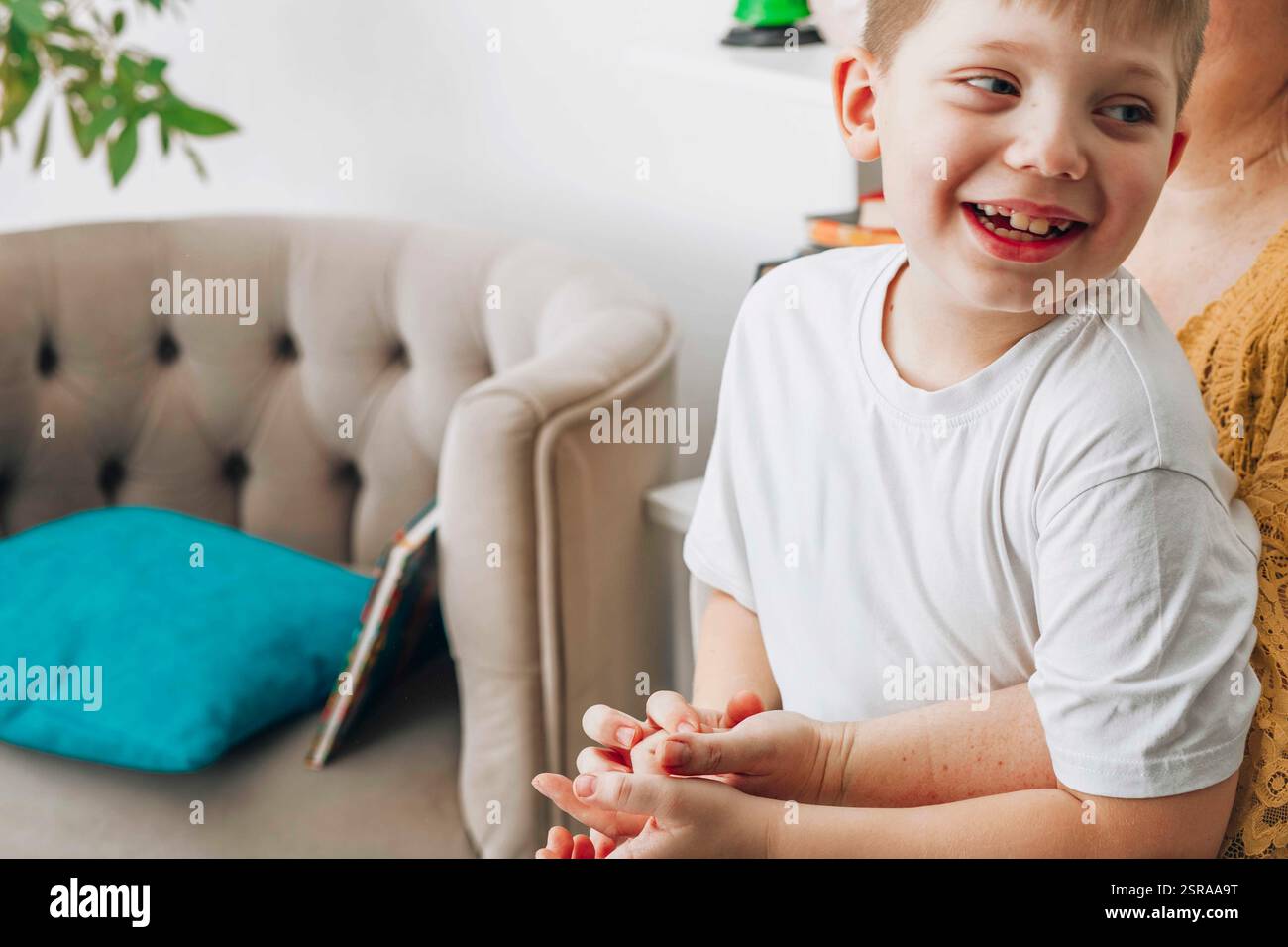 female therapist and boy practicing hand gestures in therapy session ...
