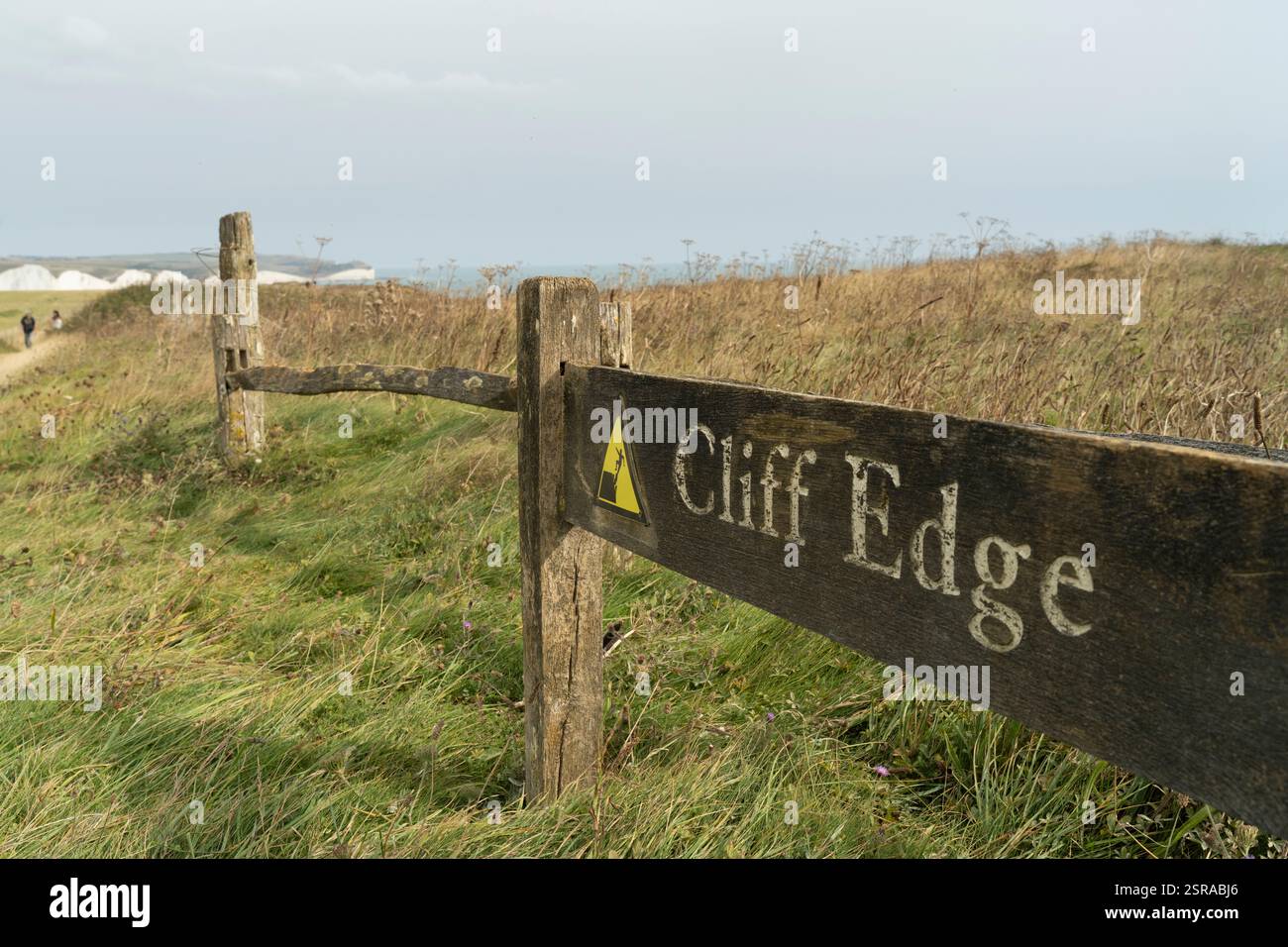 Warning sign at the cliff edge, Seven Sisters cliffs, East Sussex, UK ...