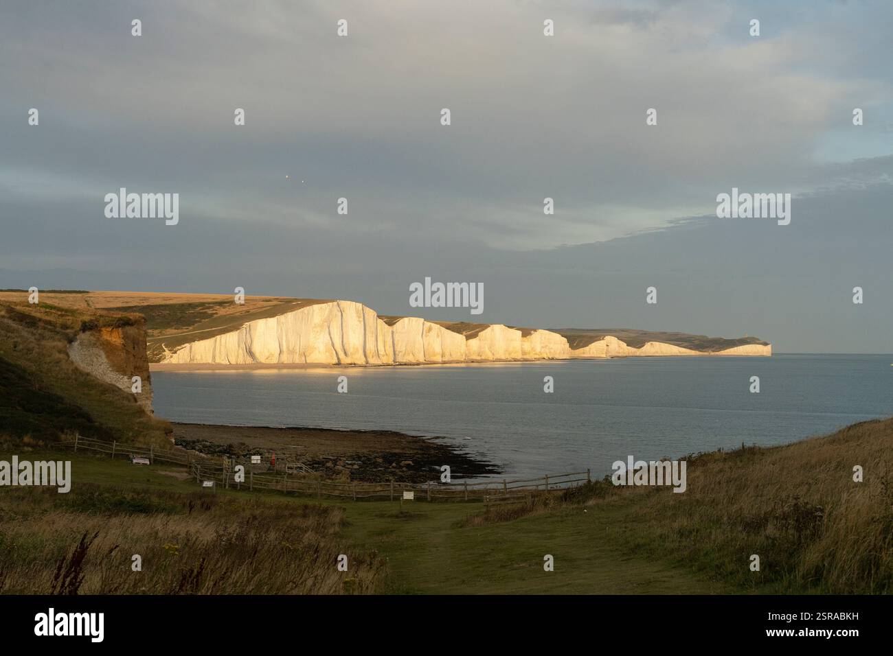 The iconic White Cliffs of Seven Sisters, England, bathed in golden ...