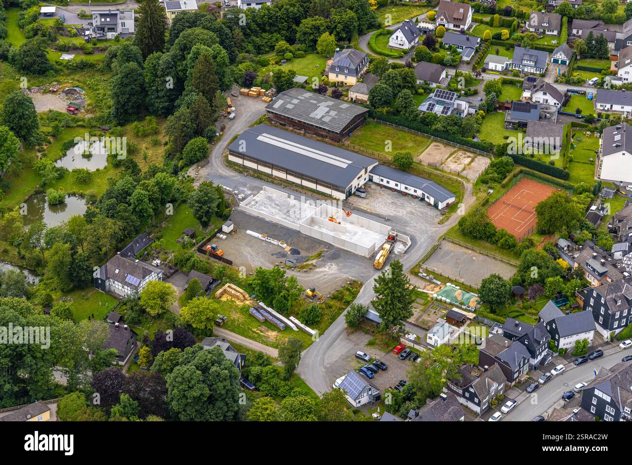 Aerial view, horse farm and riding stable, construction site with new ...
