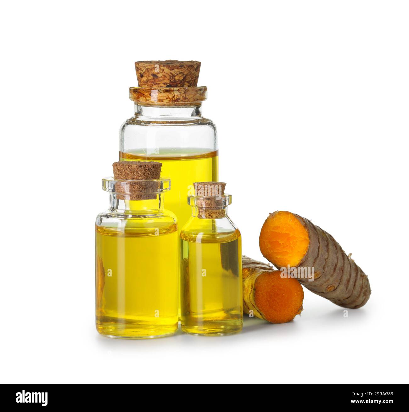 Bottles of turmeric essential oil and raw roots isolated on white Stock ...