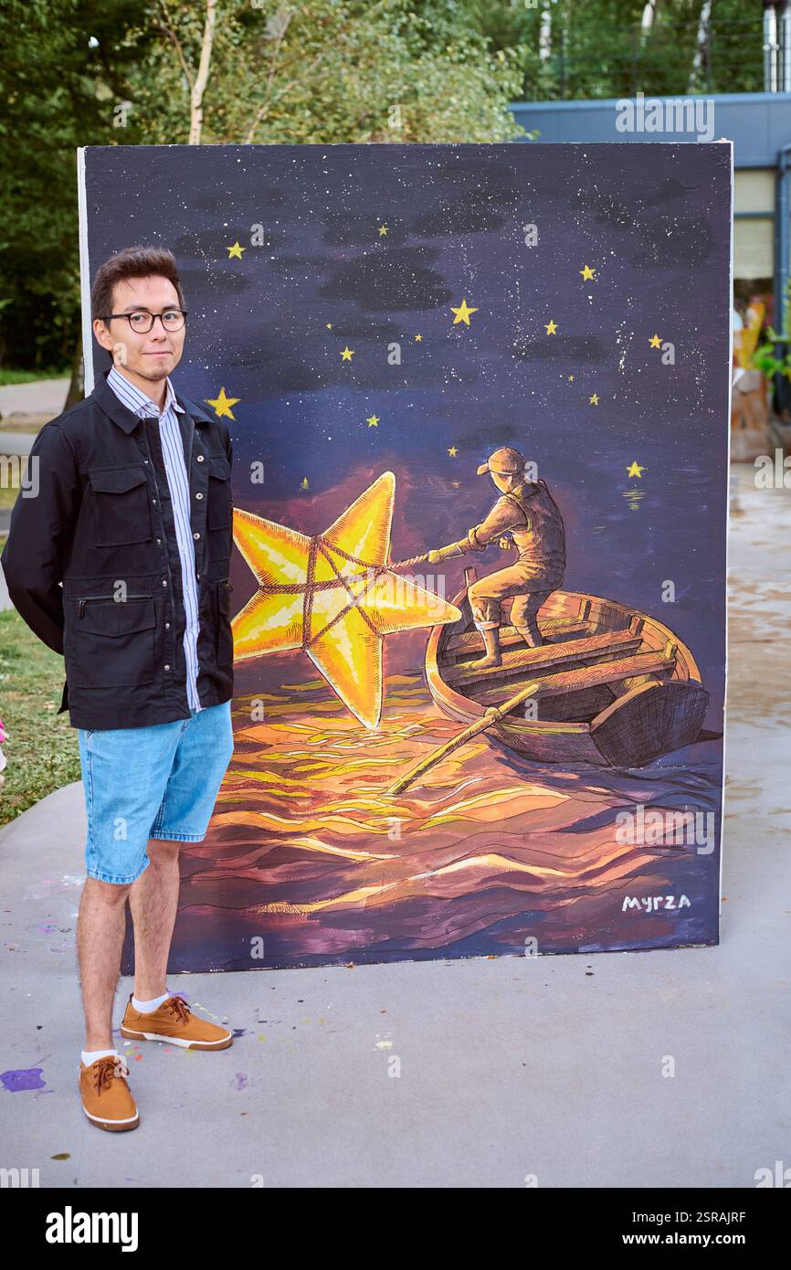 Young asian male with glasses, short black hair, stands beside large ...