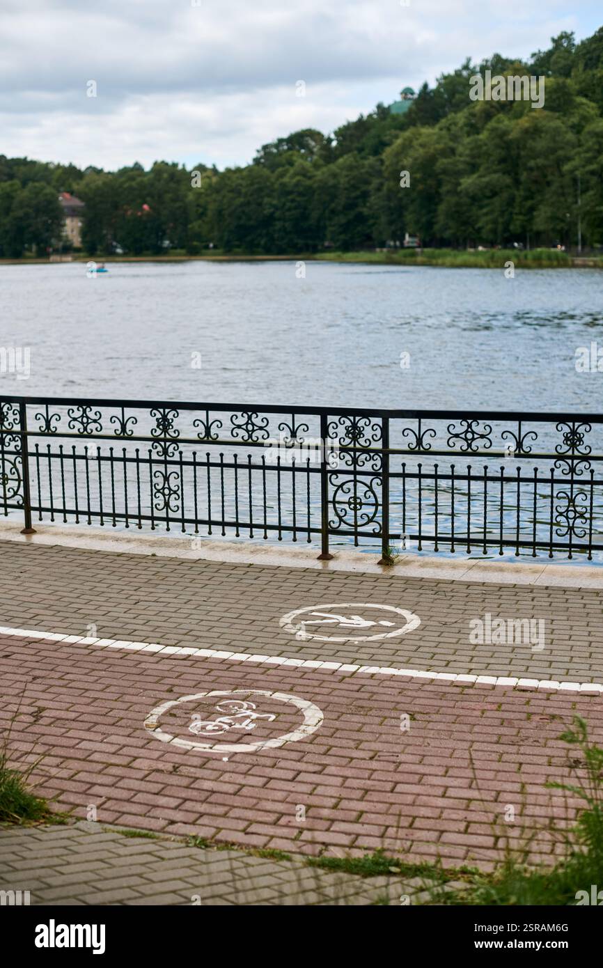 Lakeside walkway with pedestrian and bicycle symbol with distinct ...