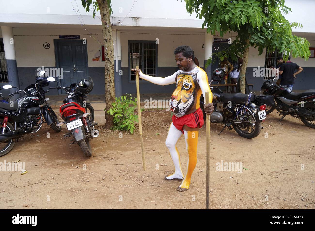 A trained dancer gets his body painted in the colours of a tiger ...