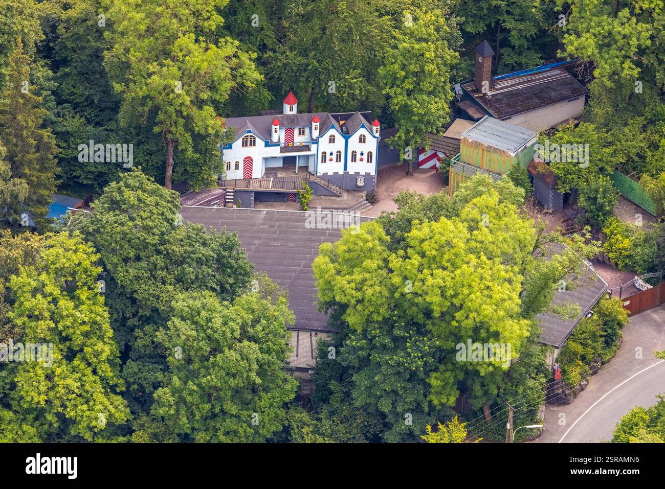 Aerial view, open-air stage covered by trees and adjacent buildings ...