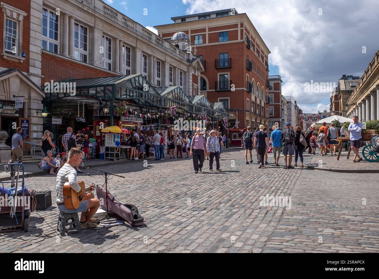 Lively street scene in Covent Garden, London, with people walking ...