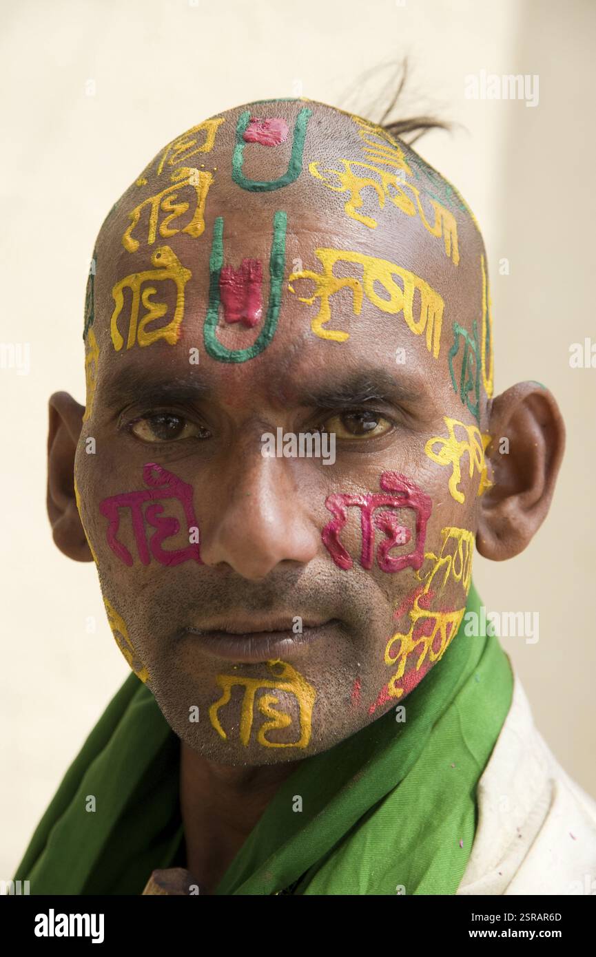 Devotee writing radhe krishna on face by sandalwood paste, uttar ...