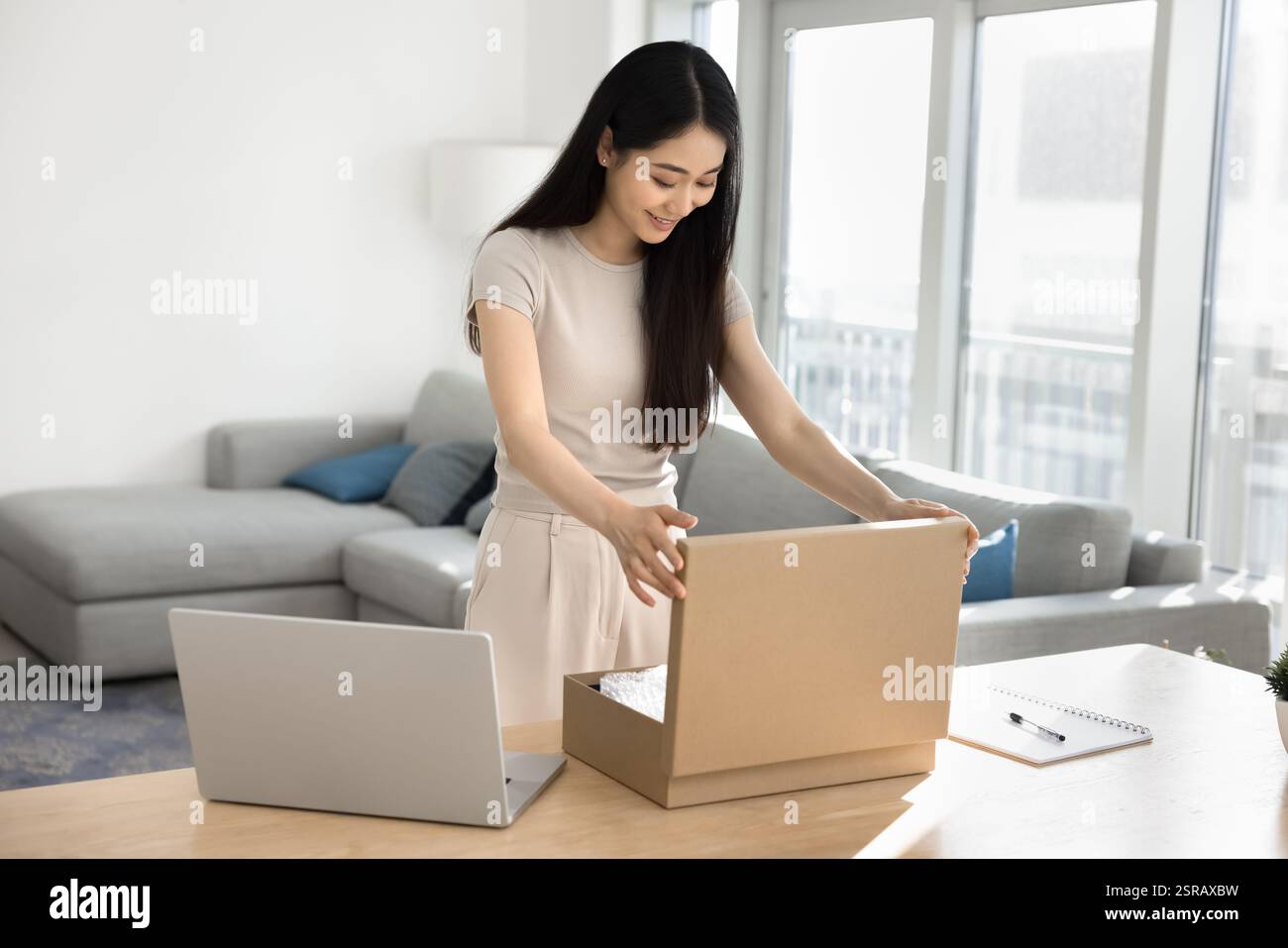Woman opening cardboard box, smile, enjoy received goods Stock Photo ...