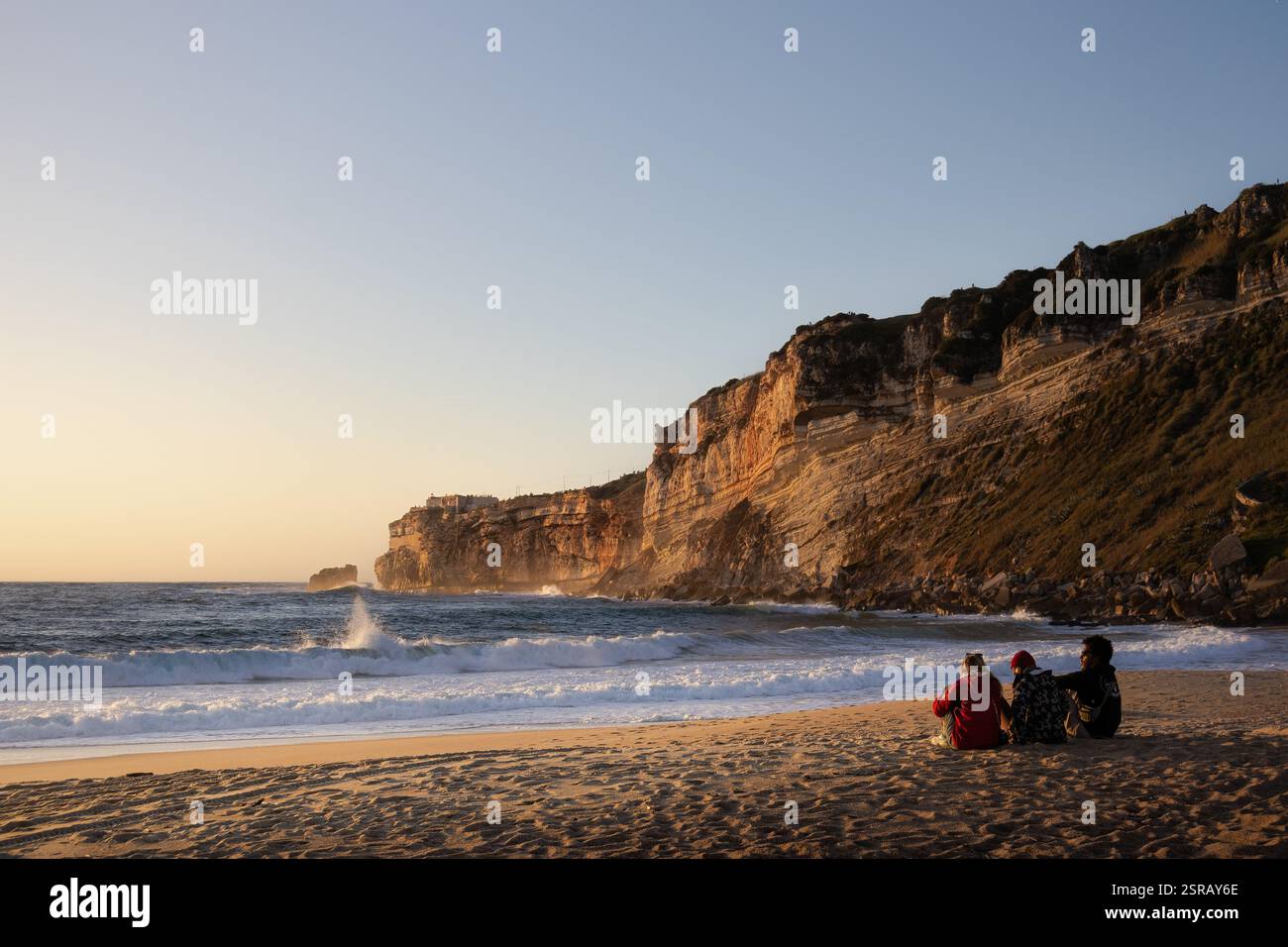 Golden hour in Nazaré – where towering cliffs meet the rhythm of the ...