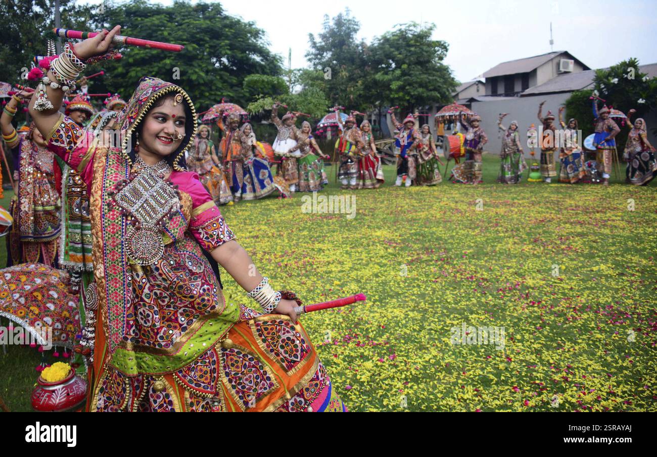 Girls in traditional attire, practice the Garba dance steps in ...