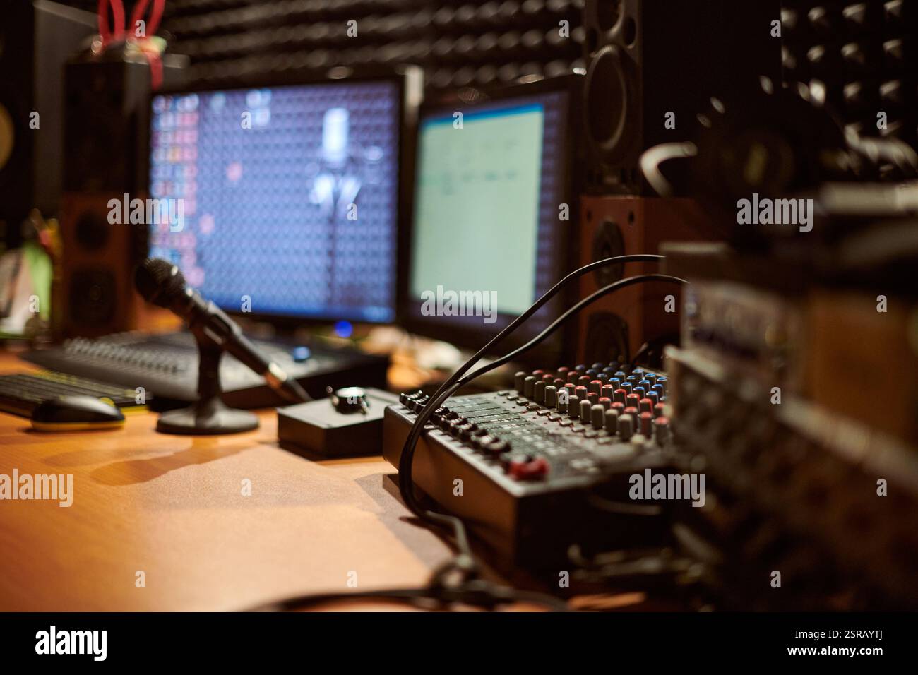 Audio mixing console with microphone in contemporary recording studio ...