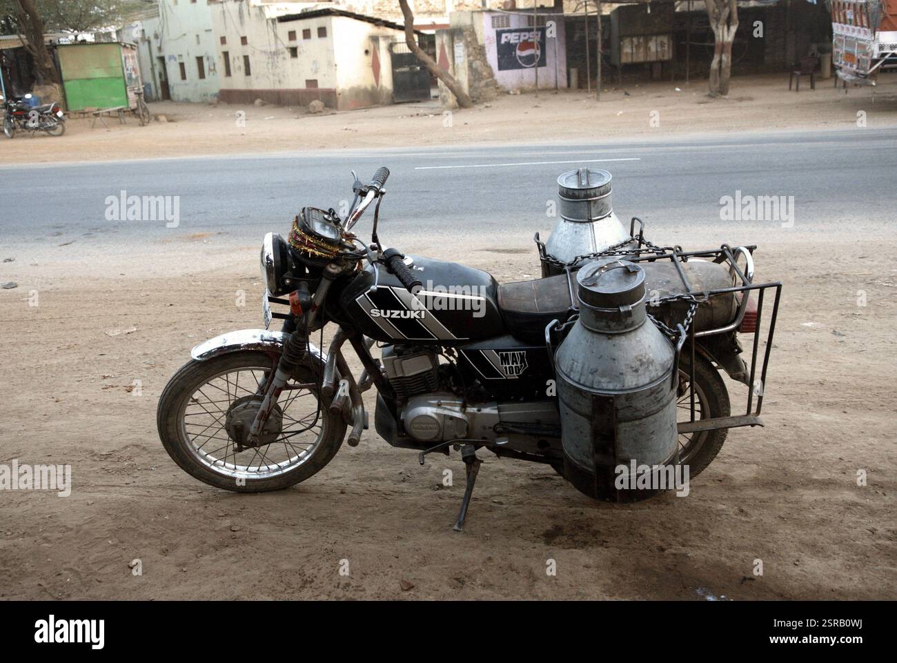 Milk cans on bike parked at Udaipur Ahmedabad highway, Rajasthan, India ...