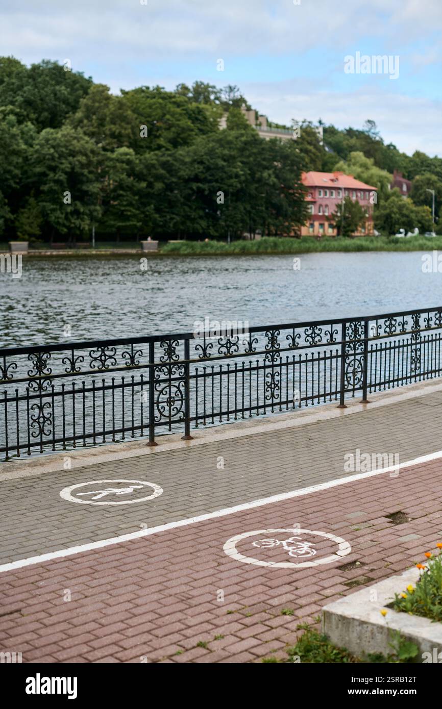 Lakeside walkway with pedestrian and bicycle symbol with distinct ...