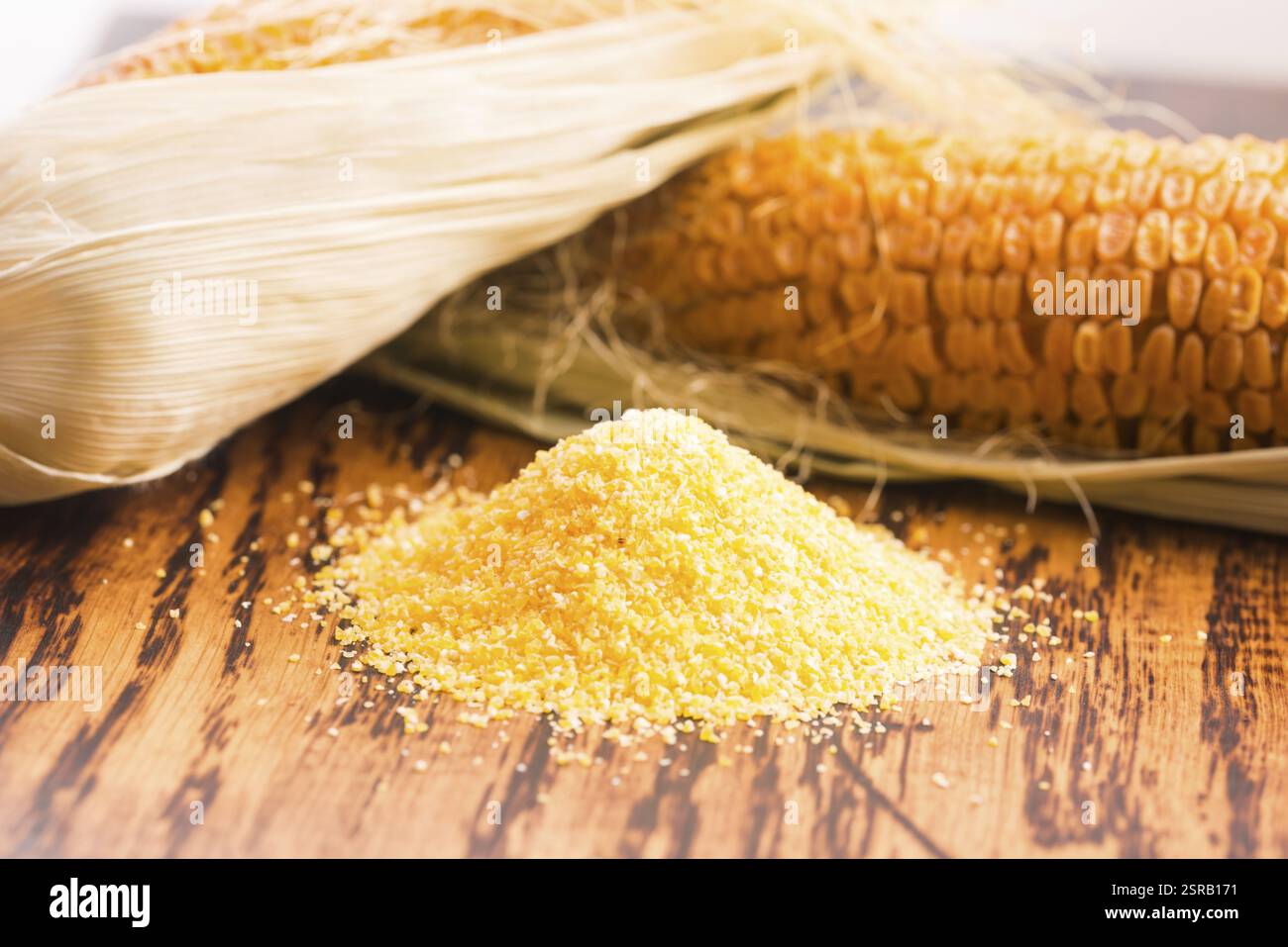 Corn groats and seeds, corncobs on wooden rustic table Stock Photo - Alamy