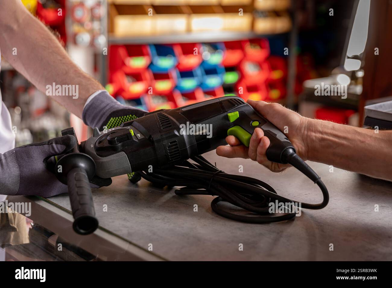 The process of handing over a power tool at a hardware store is an ...
