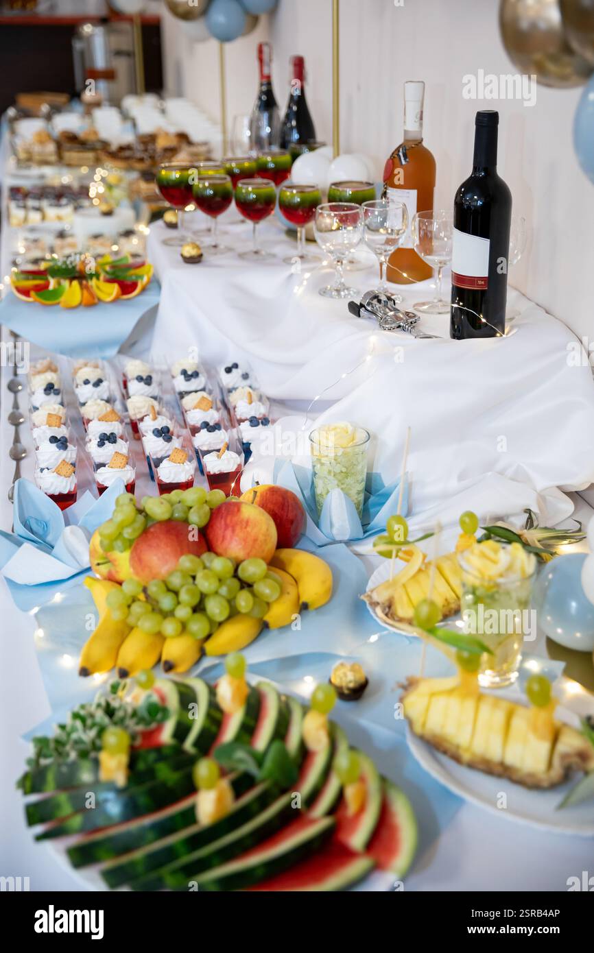An Elegant Buffet Table Setup Featuring an Assortment of Fresh Fruits and Refreshing Drinks ...