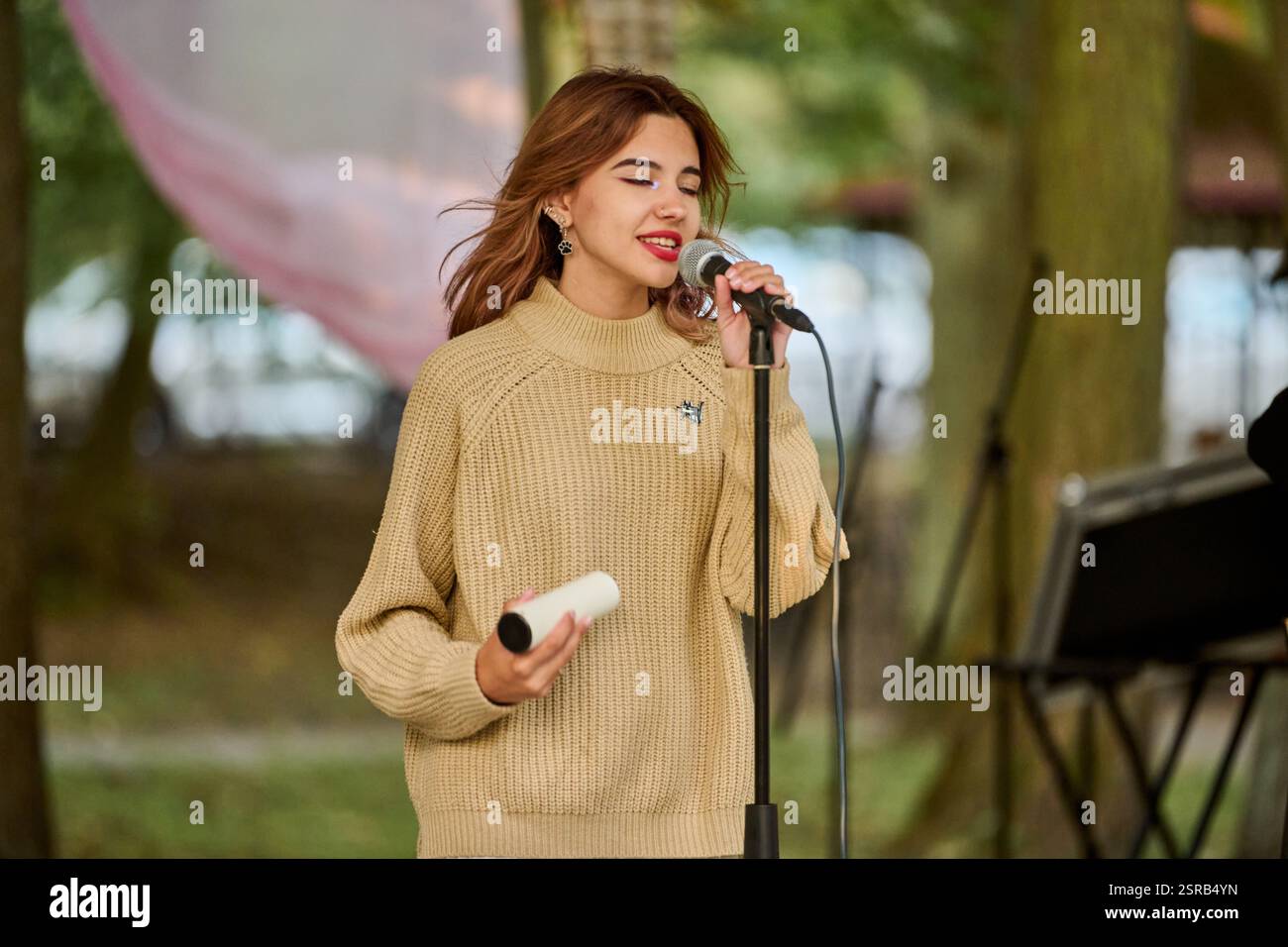 Kaliningrad, Russia - 10.08.2024 - Young woman sings passionately ...