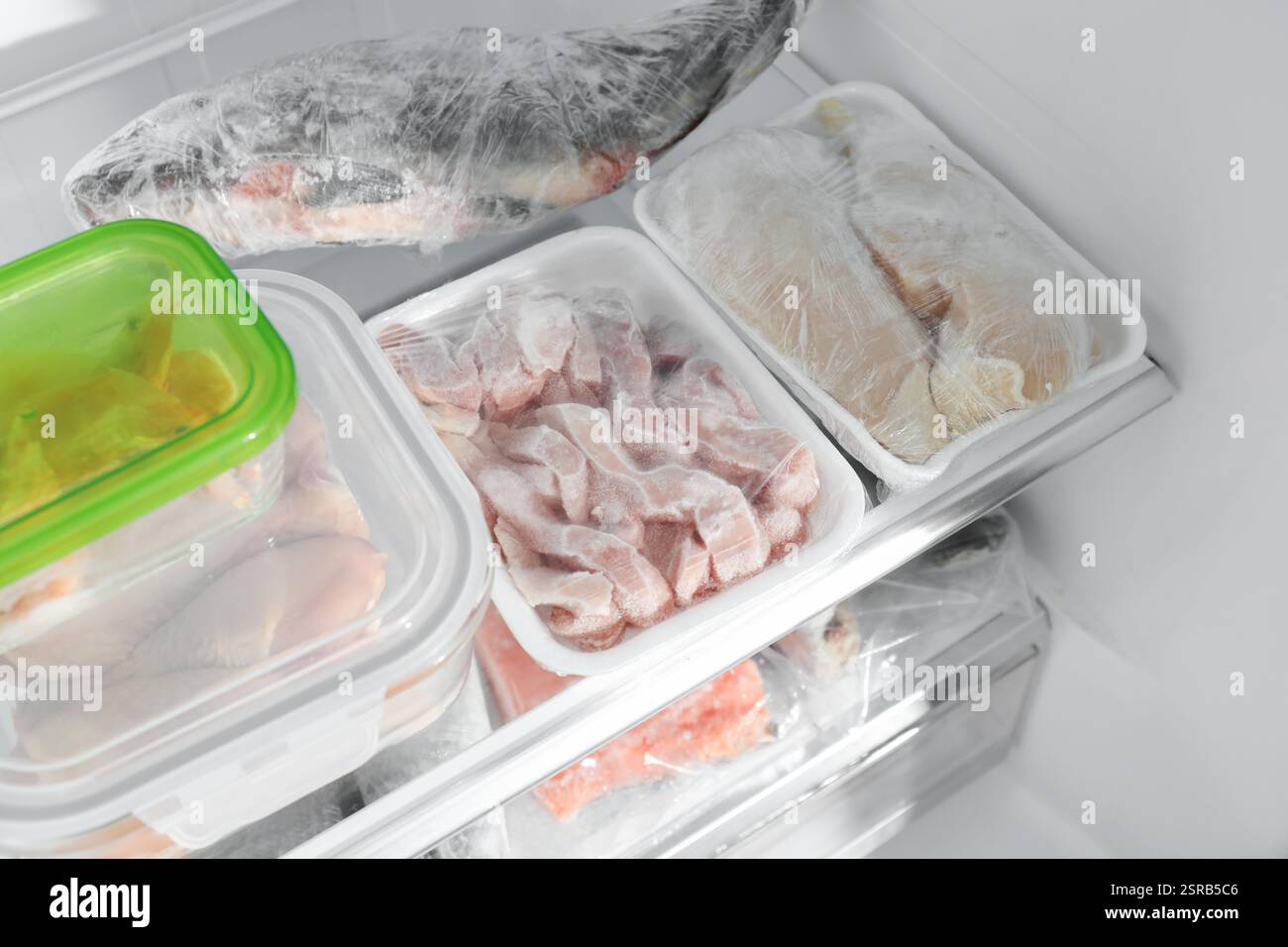 Different frozen meat and fish products in fridge Stock Photo - Alamy