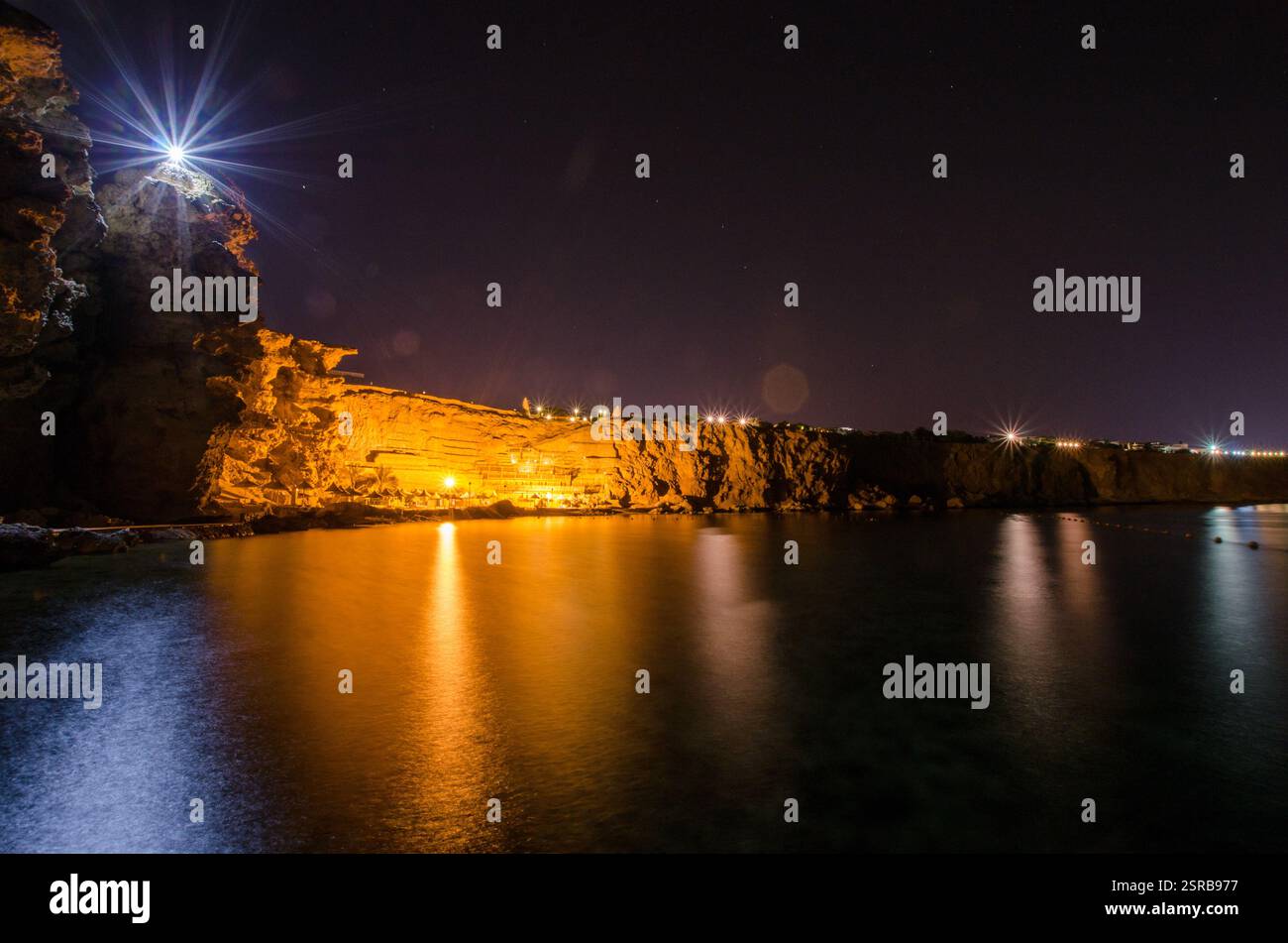 Coastal resort showcases serene night ambiance with illuminated rocky ...