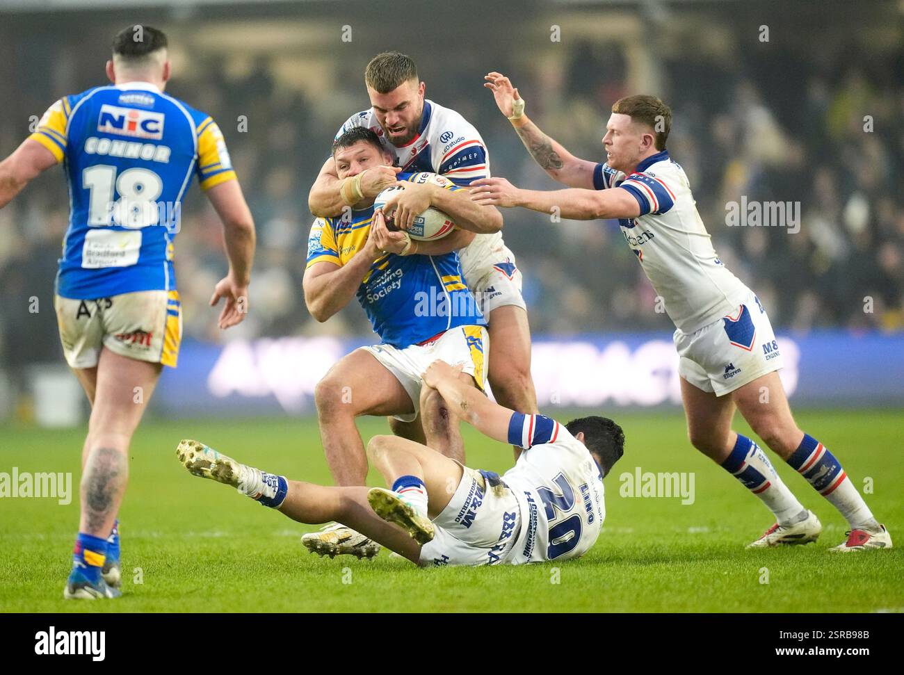 Leeds Rhinos' Ryan Hall is tackled by Wakefield Trinity's Mike McMeeken ...