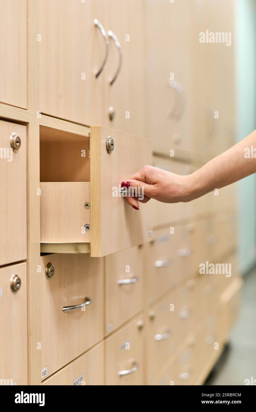 Young adult woman with red nails opens wooden drawer in pharmacy. Soft ...