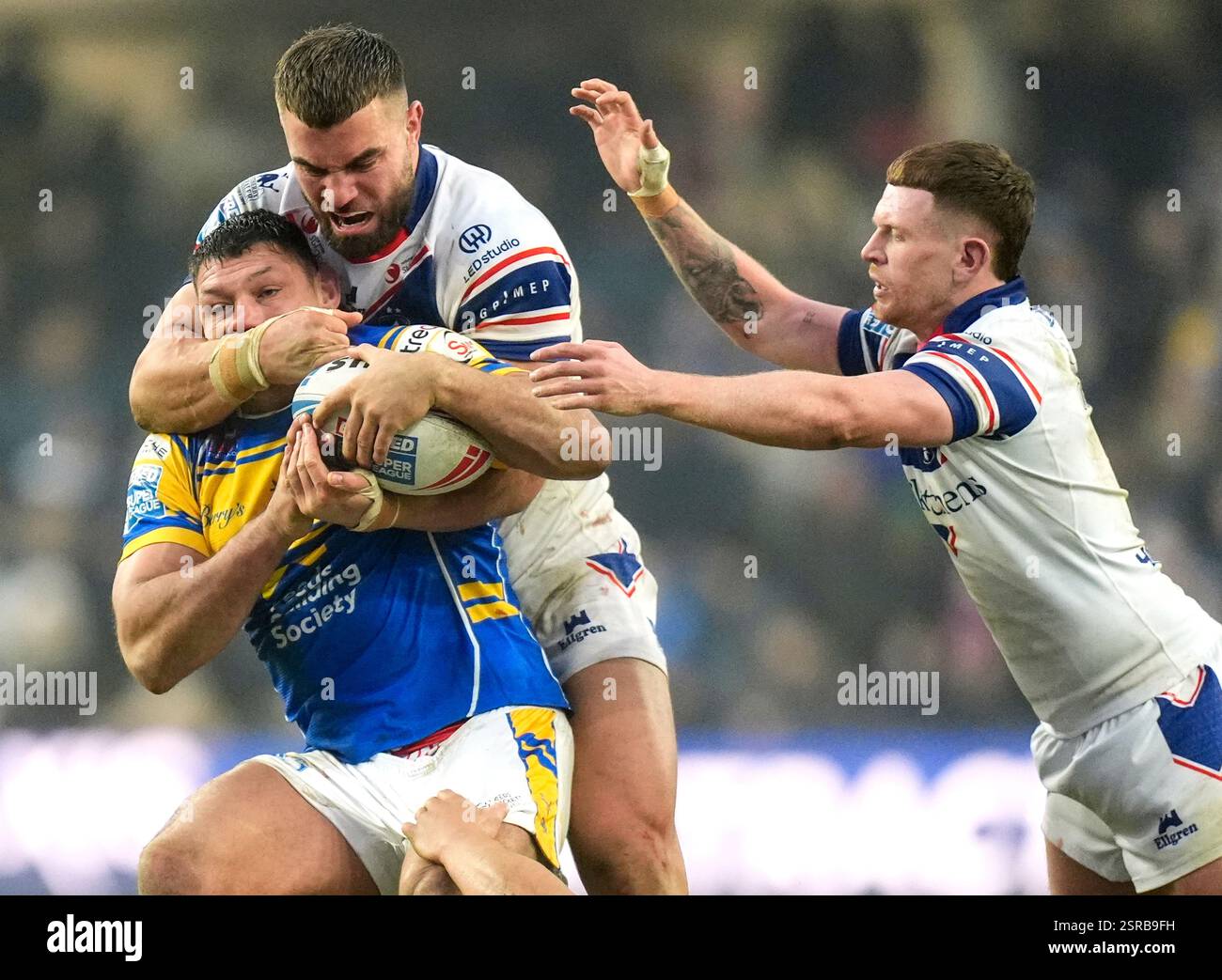 Leeds Rhinos' Ryan Hall is tackled by Wakefield Trinity's Mike McMeeken ...