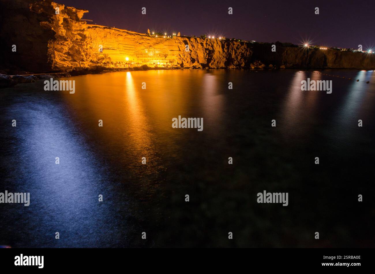 Coastal resort showcases serene night ambiance with illuminated rocky ...