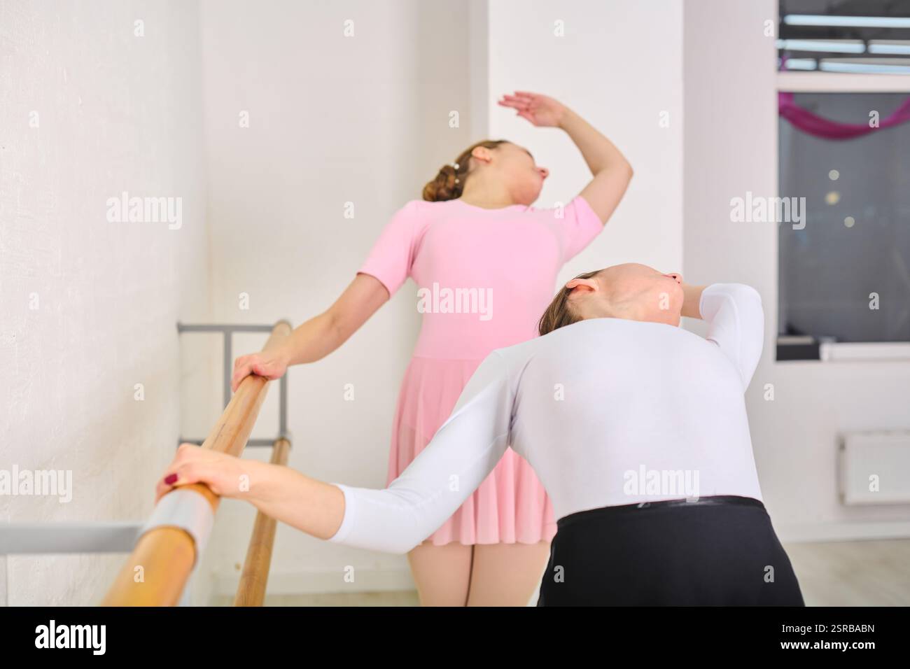 Two young female ballerinas, fair-haired and white-skinned, elegantly ...
