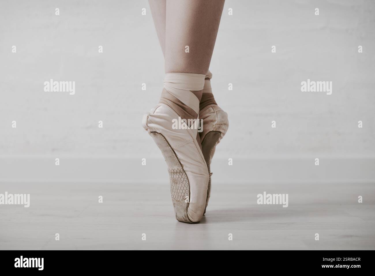 Close-up of young female adult ballet dancers feet in pointe shoes ...